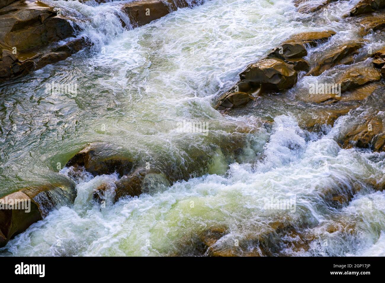 Aerial view of river waterfall with clear turquoise water falling down ...