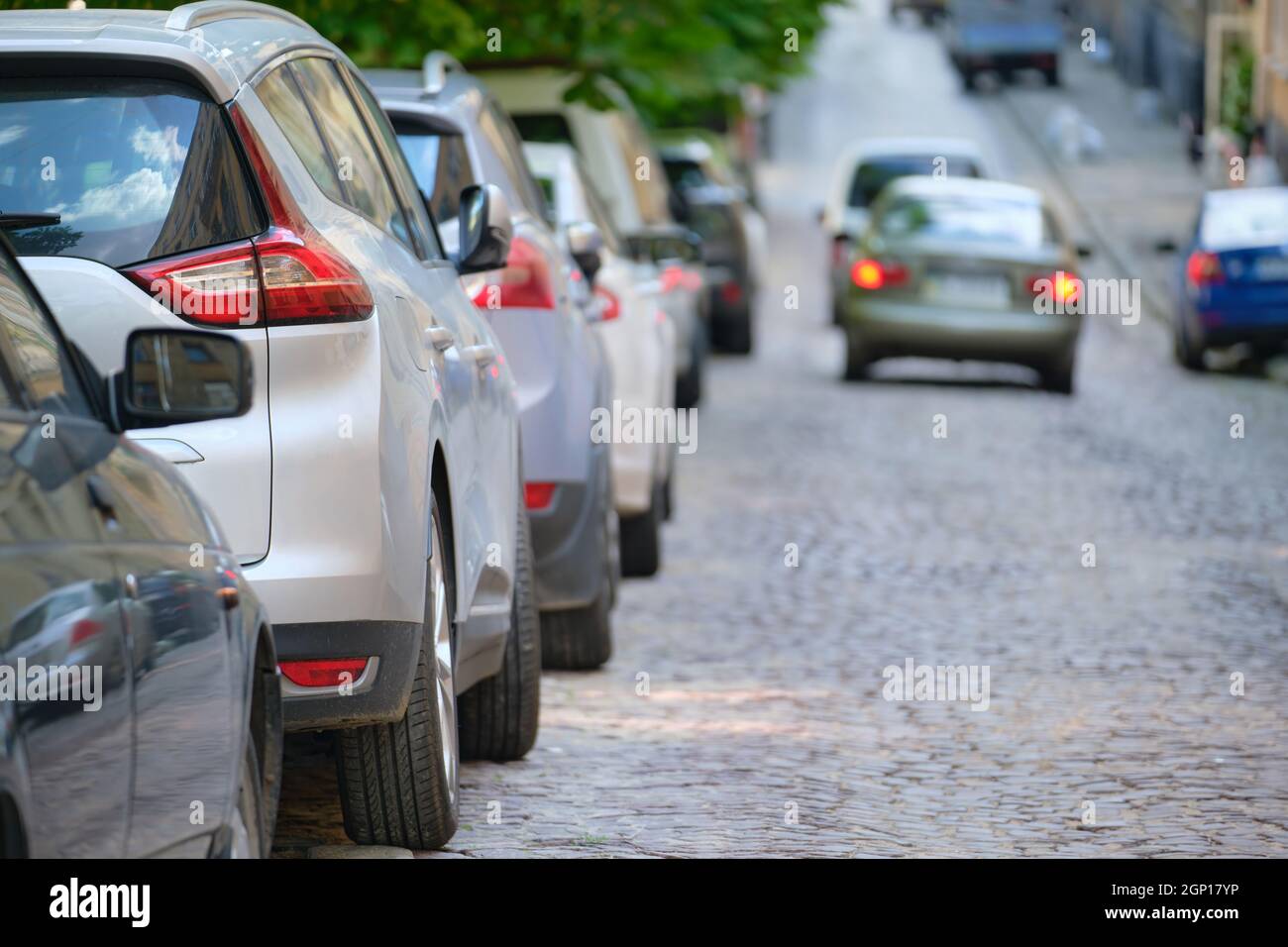 City traffic with cars parked in line on street side Stock Photo - Alamy