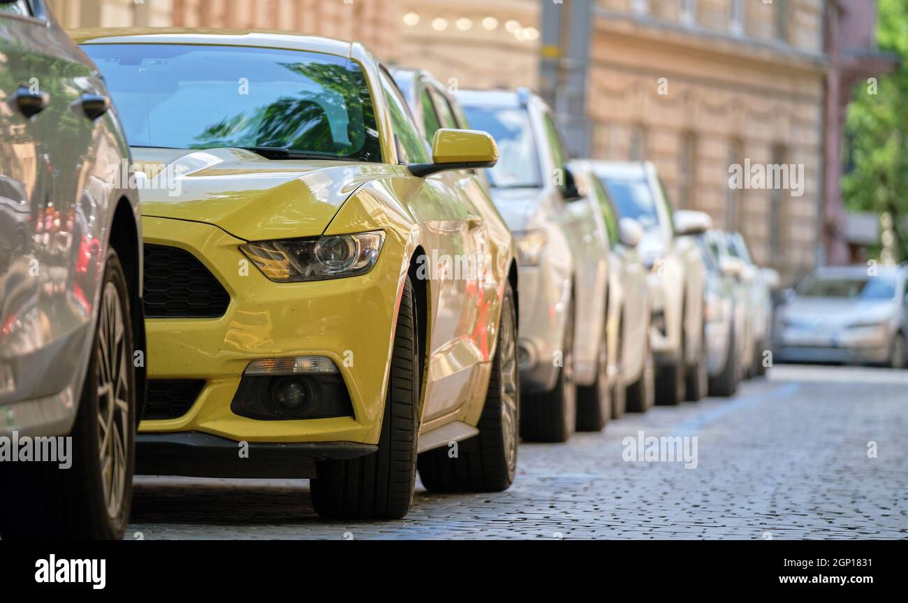 City traffic with cars parked in line on street side Stock Photo - Alamy