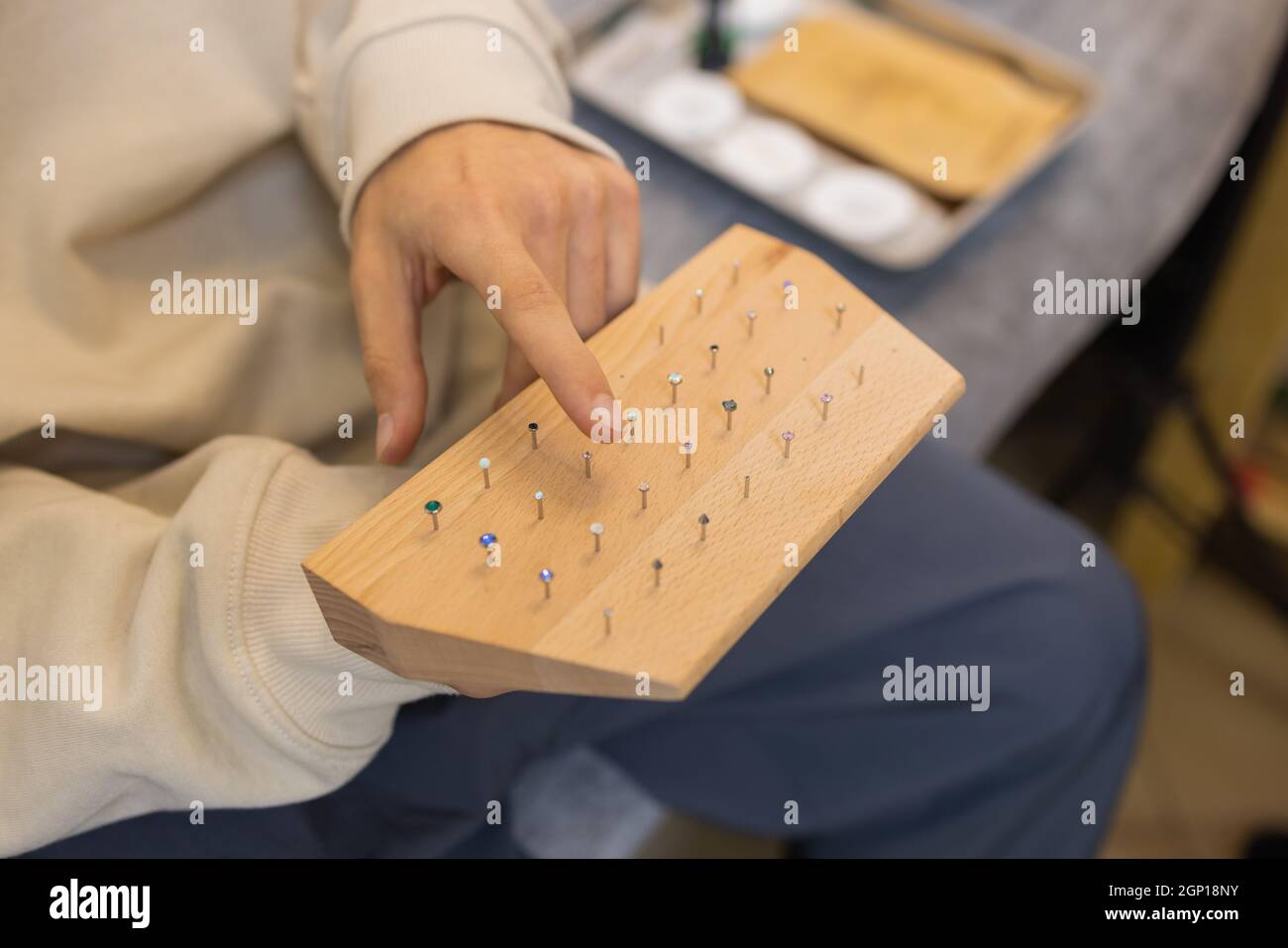 ear jewelry, piercing in hand with a disposable glove Stock Photo - Alamy