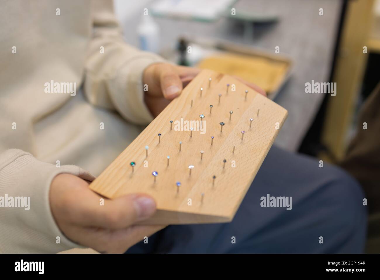 ear jewelry, piercing in hand with a disposable glove Stock Photo - Alamy