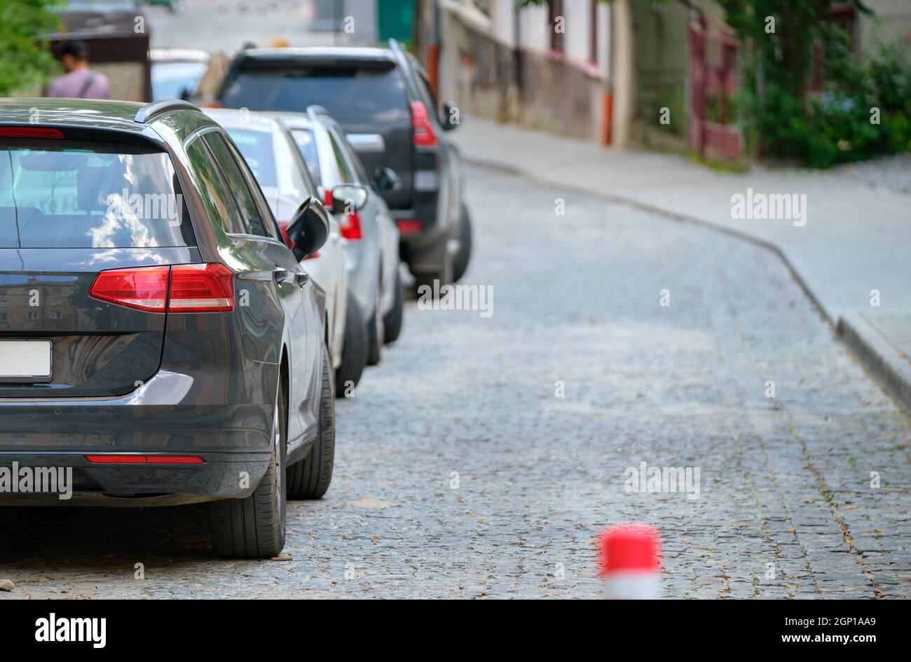 City traffic with cars parked in line on street side Stock Photo - Alamy