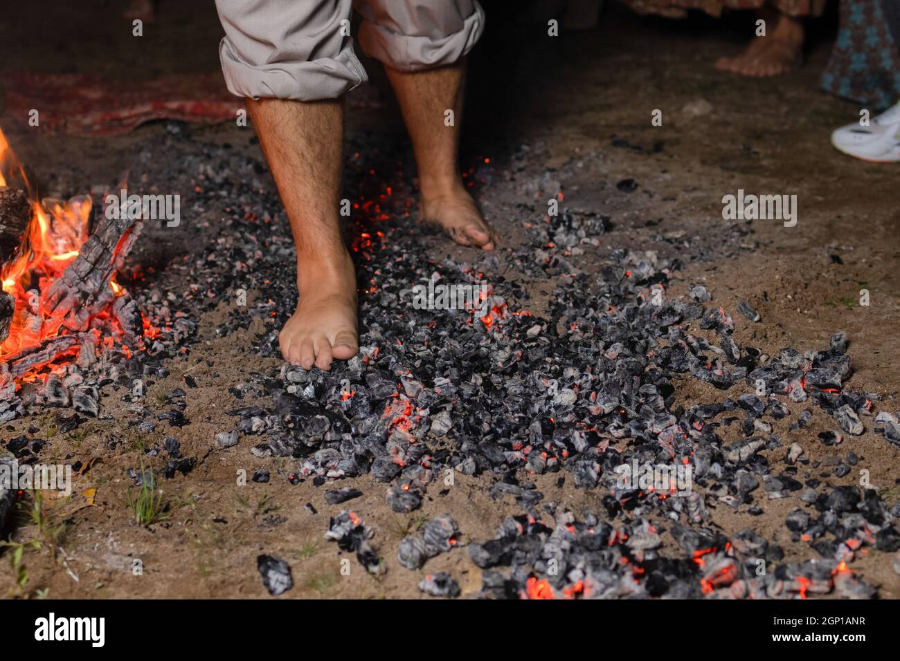 Walking on the burning cinders close-up side view Stock Photo - Alamy