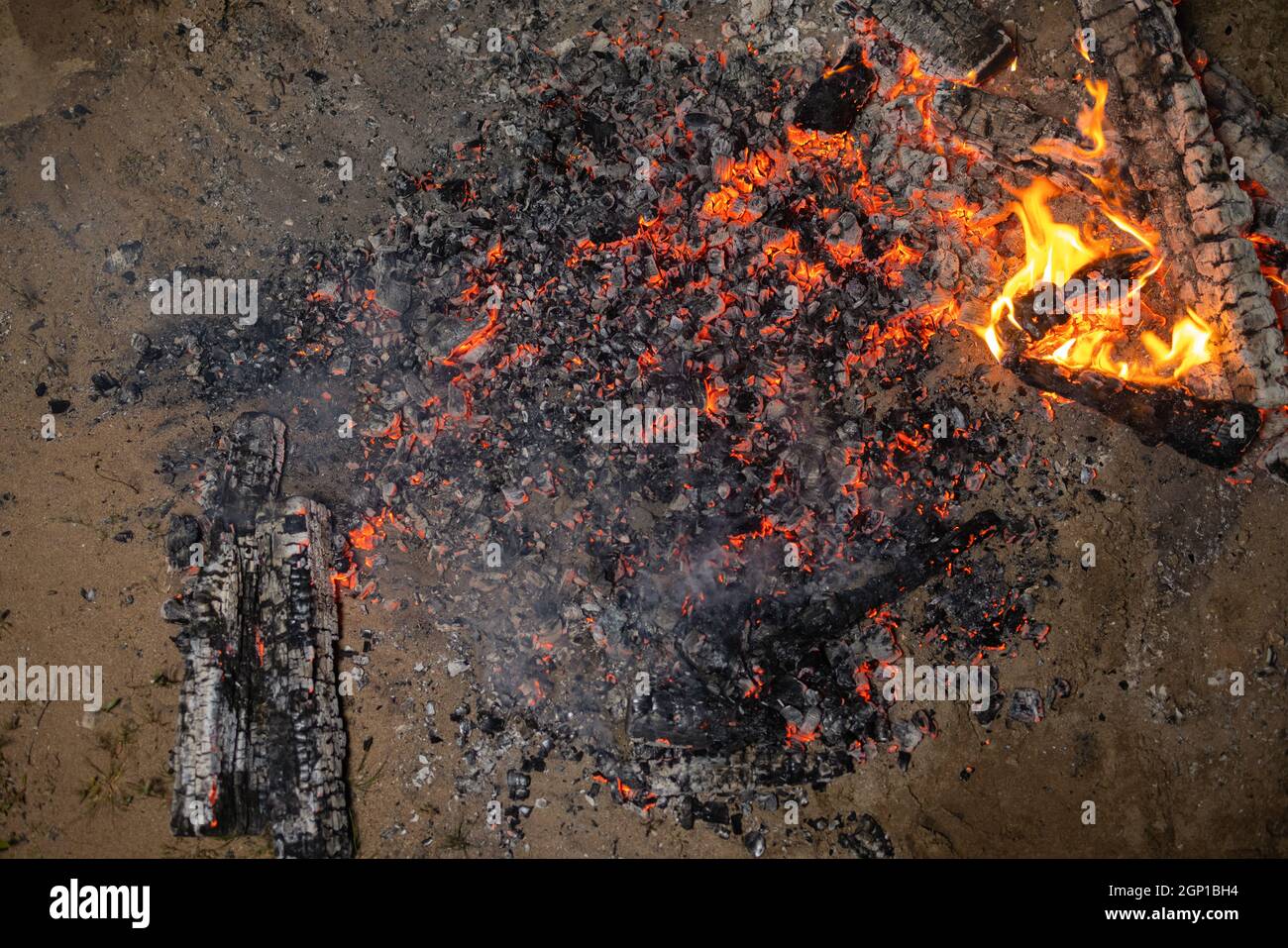 Walking on the burning cinders close-up side view Stock Photo - Alamy