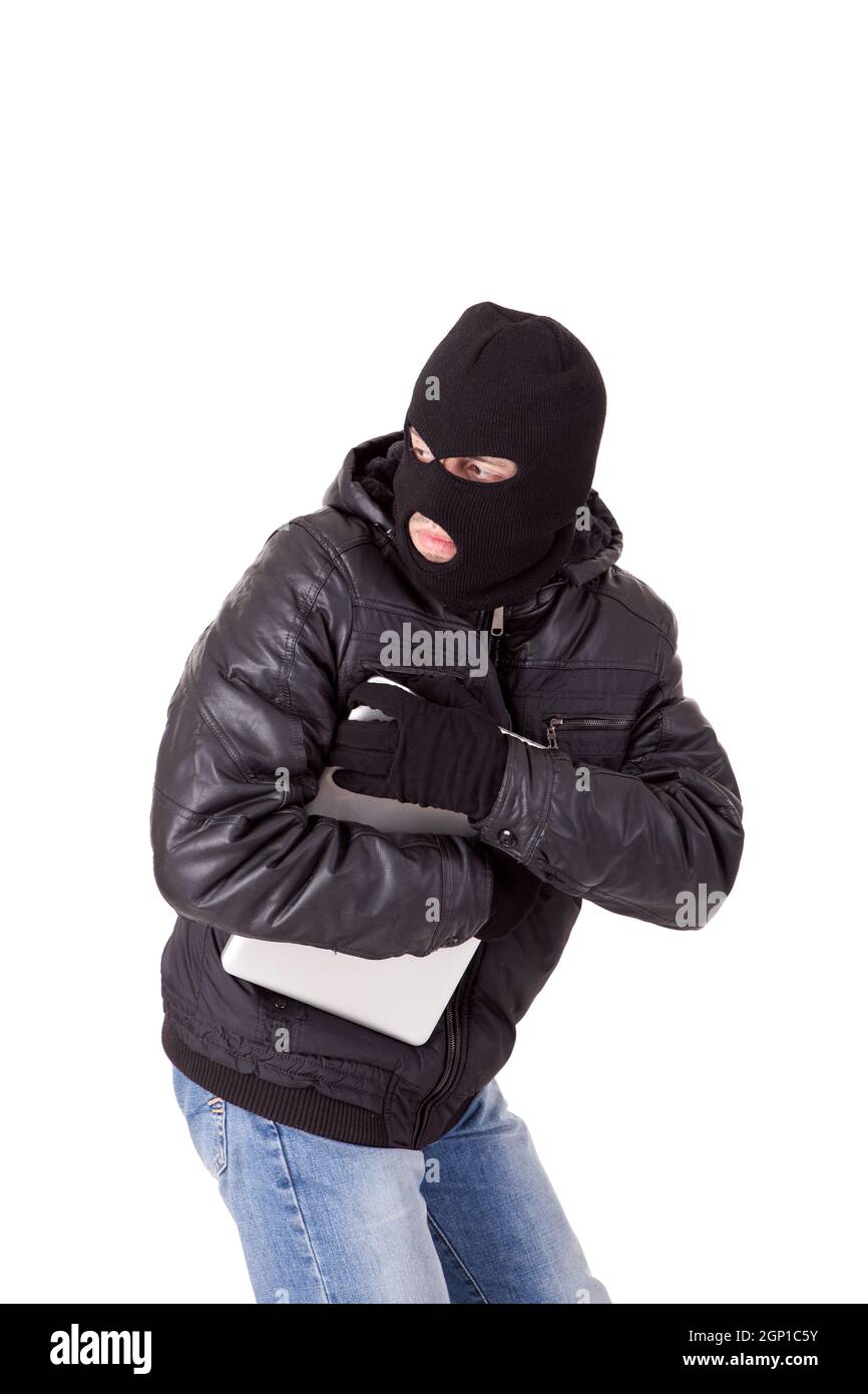 Thief holding a laptop, isolated over white background Stock Photo - Alamy