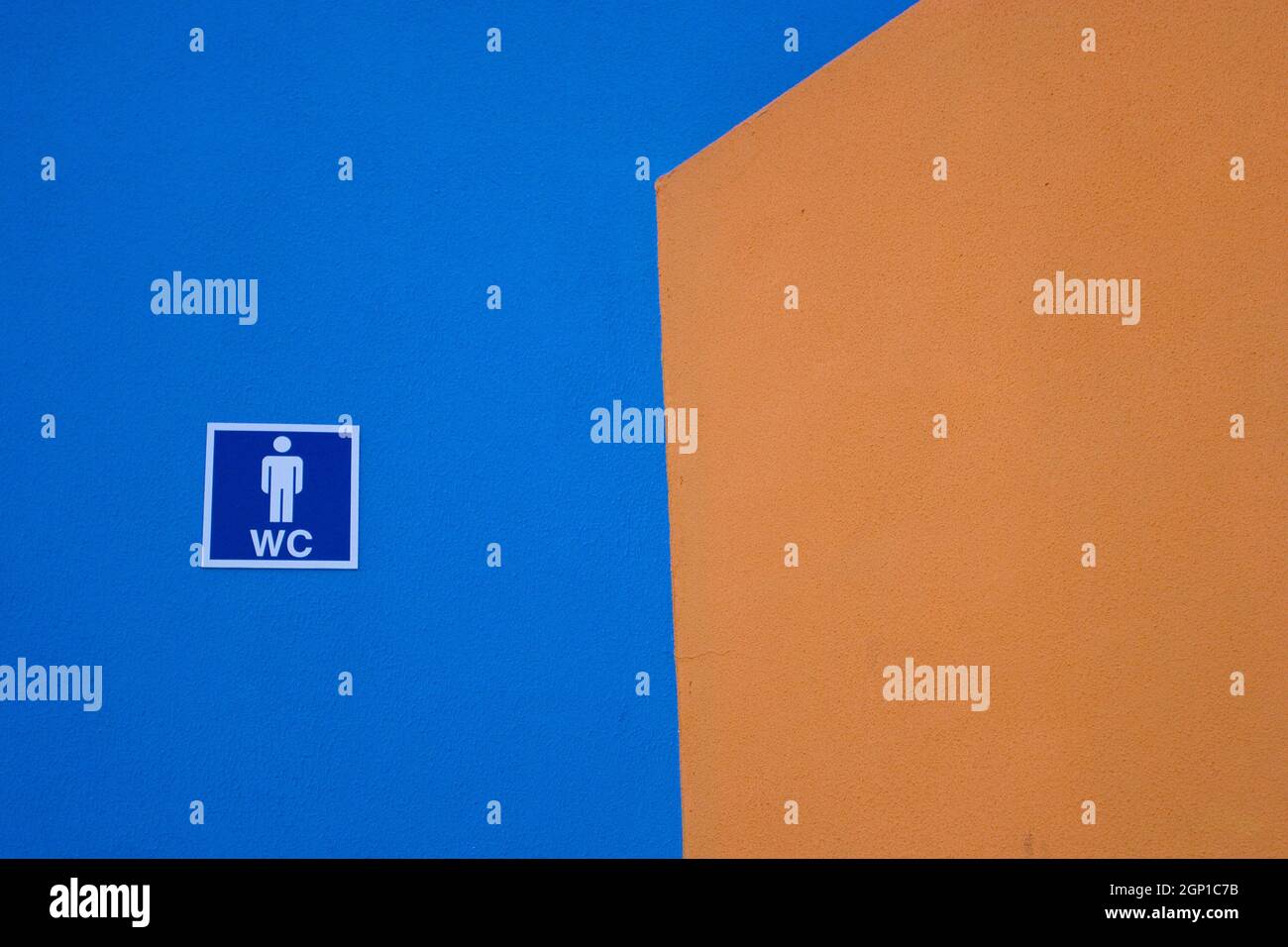 Detail of a Men's WC Sign, in a colorful blue and orange background ...