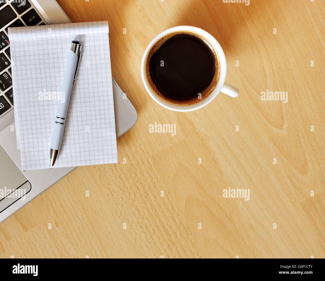 Laptop with coffee cup, notebook and pen on wooden background, concept ...