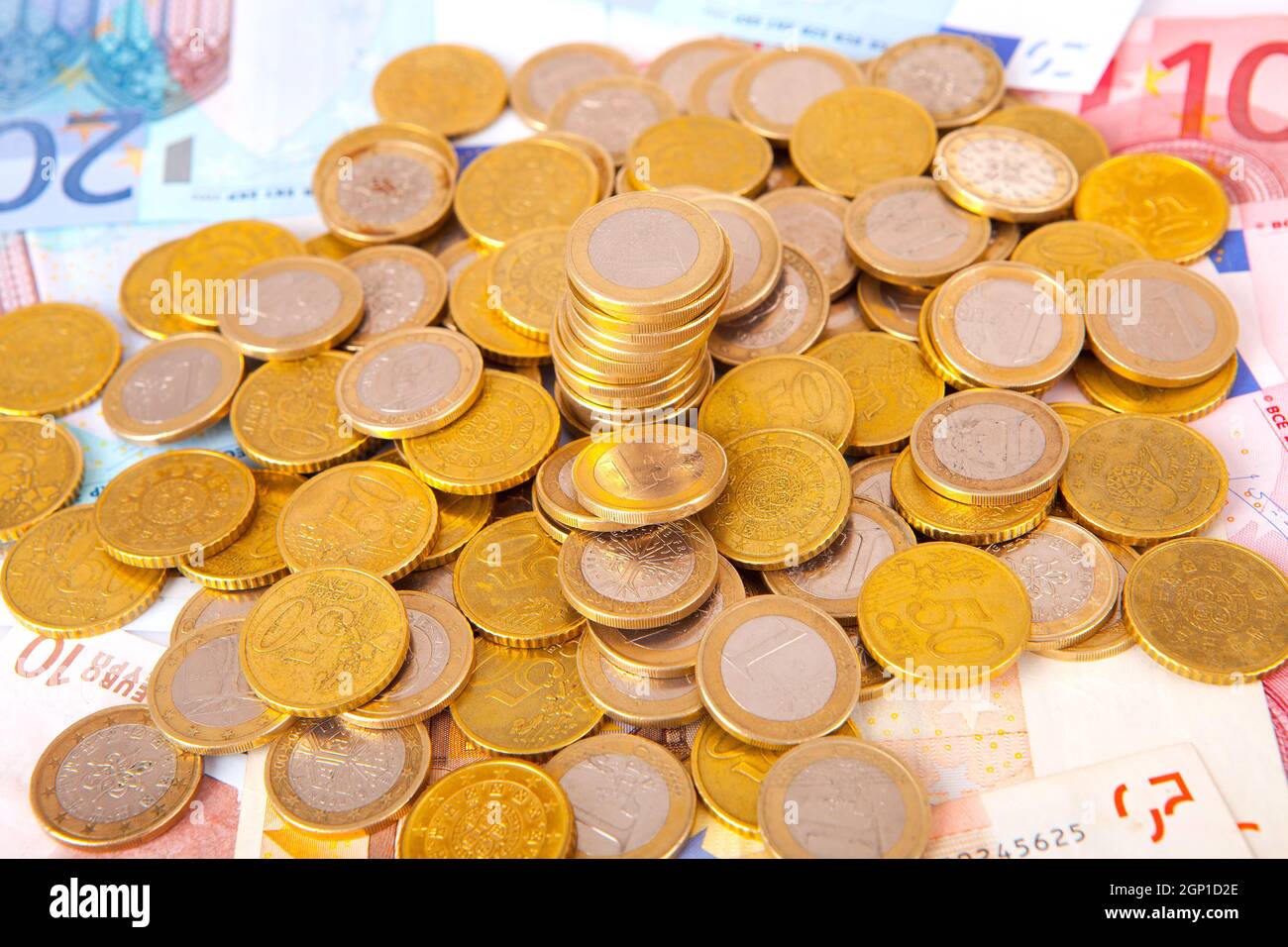Pile of notes and coins Stock Photo - Alamy