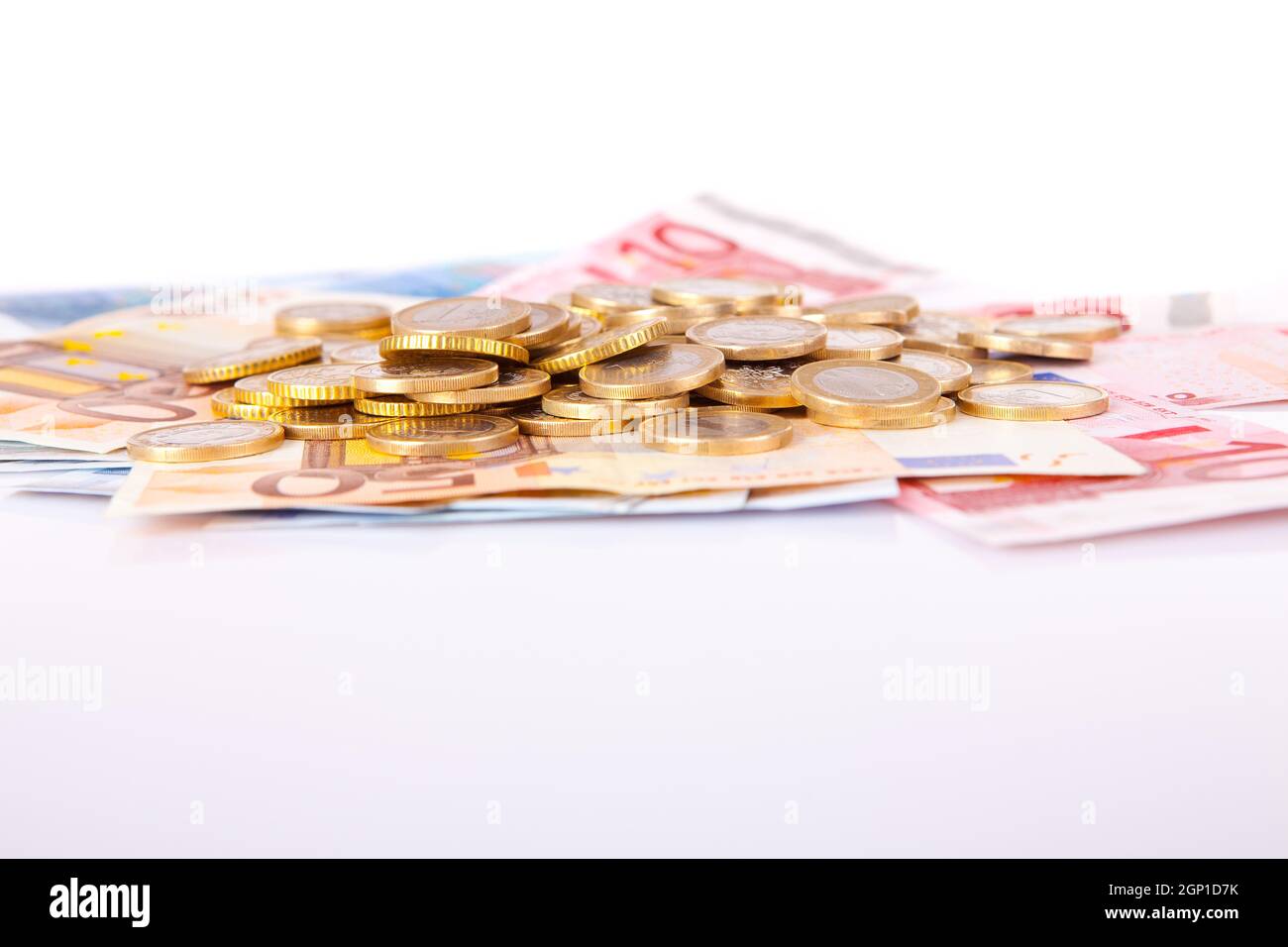 Pile of notes and coins Stock Photo - Alamy