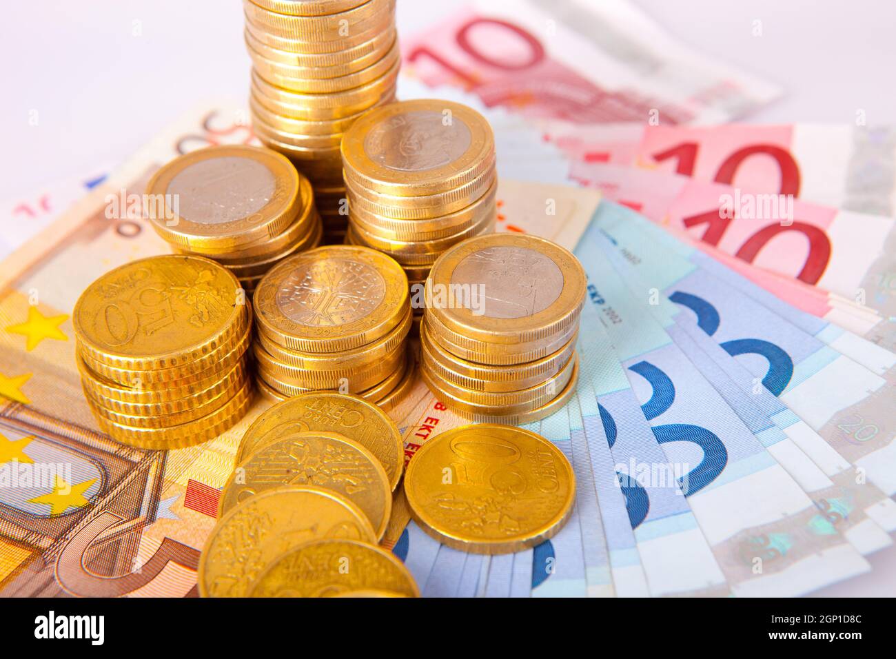 Pile of notes and coins Stock Photo - Alamy