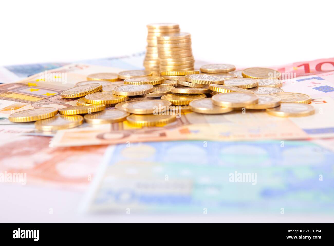 Pile of notes and coins Stock Photo - Alamy