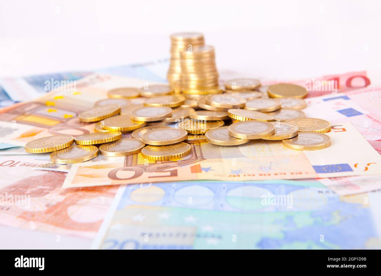 Pile of notes and coins Stock Photo - Alamy