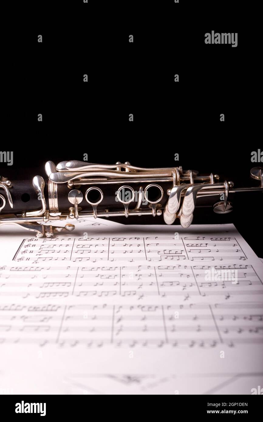 Detail of a clarinet, isolated over sheet music Stock Photo - Alamy