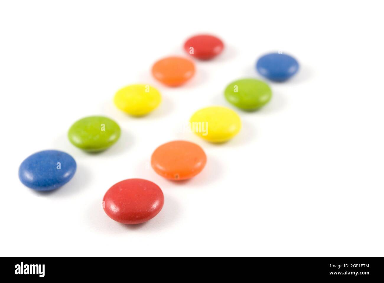 Pile of colored smarties - focus on the red one Stock Photo - Alamy