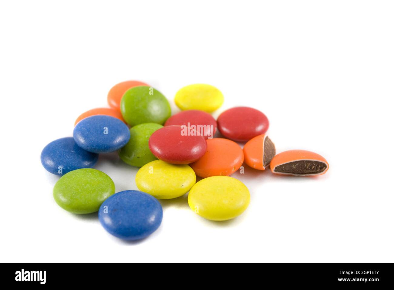 Pile of colored chocolates, isolated over white background Stock Photo ...