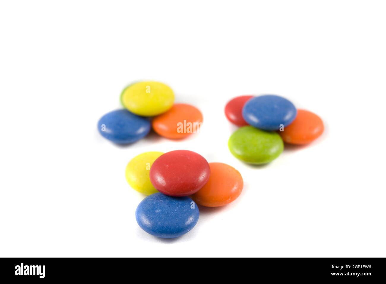 Pile of colored chocolates, isolated over white background Stock Photo ...