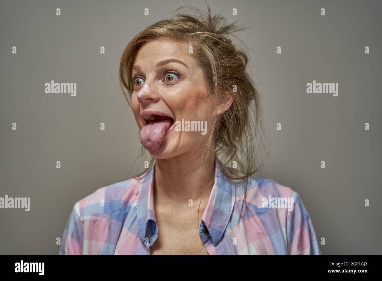 Young blonde woman shows tongue hi-res stock photography and images - Alamy