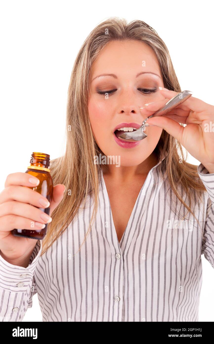 Beautiful young ill woman drinking syrup Stock Photo - Alamy