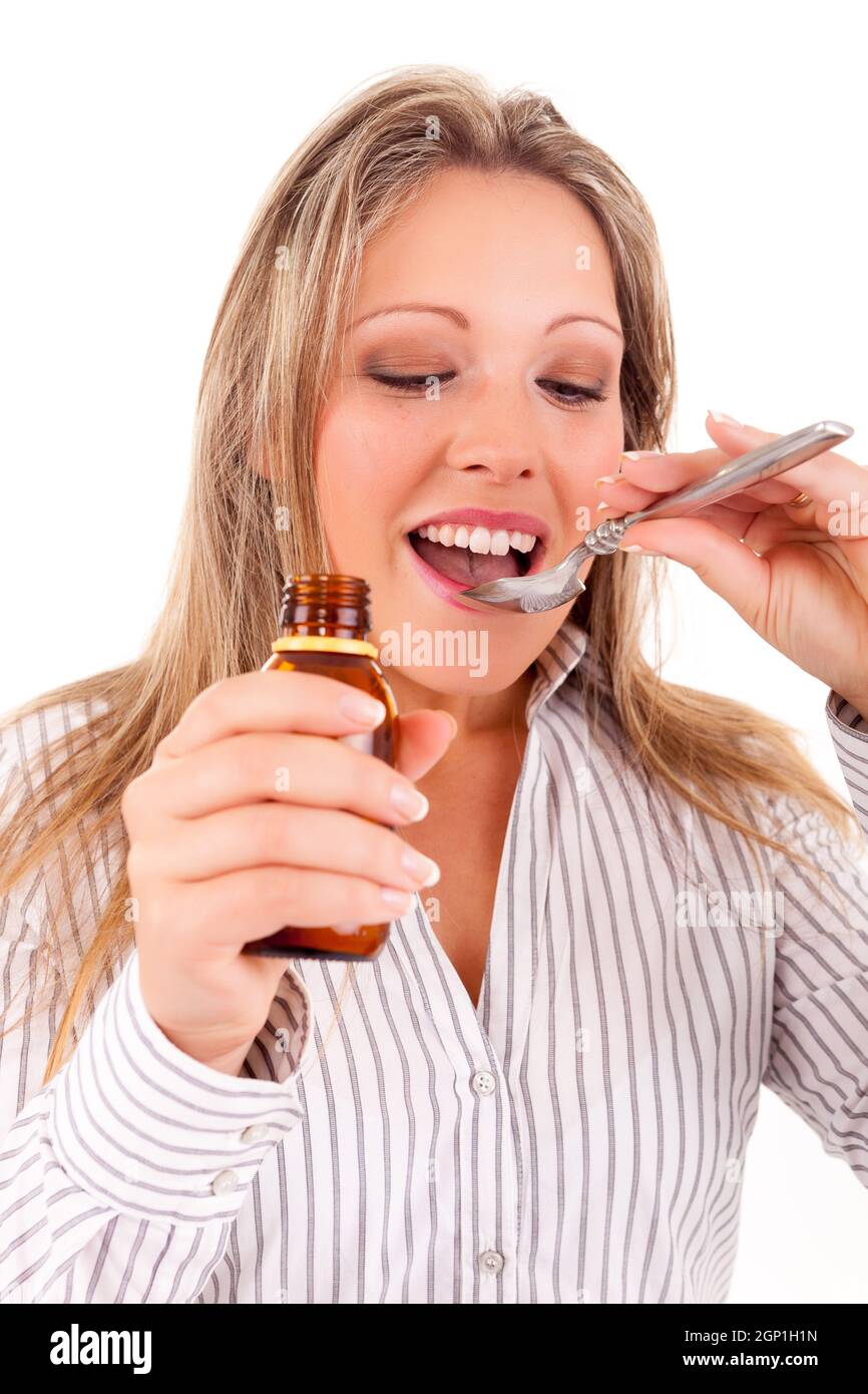 Beautiful young ill woman drinking syrup Stock Photo - Alamy