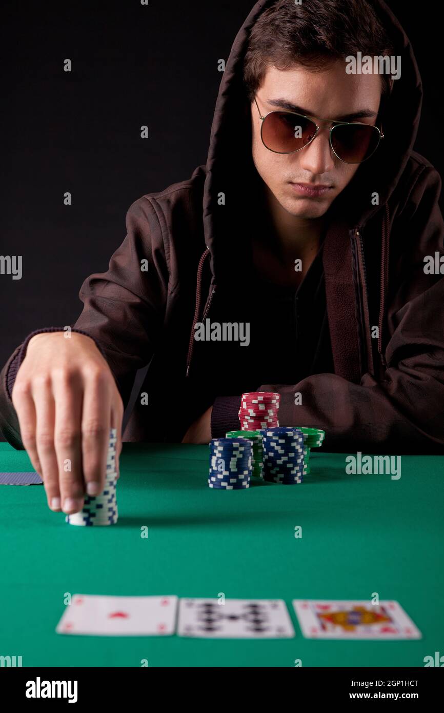 Young handsome man playing texas hold'em poker Stock Photo - Alamy