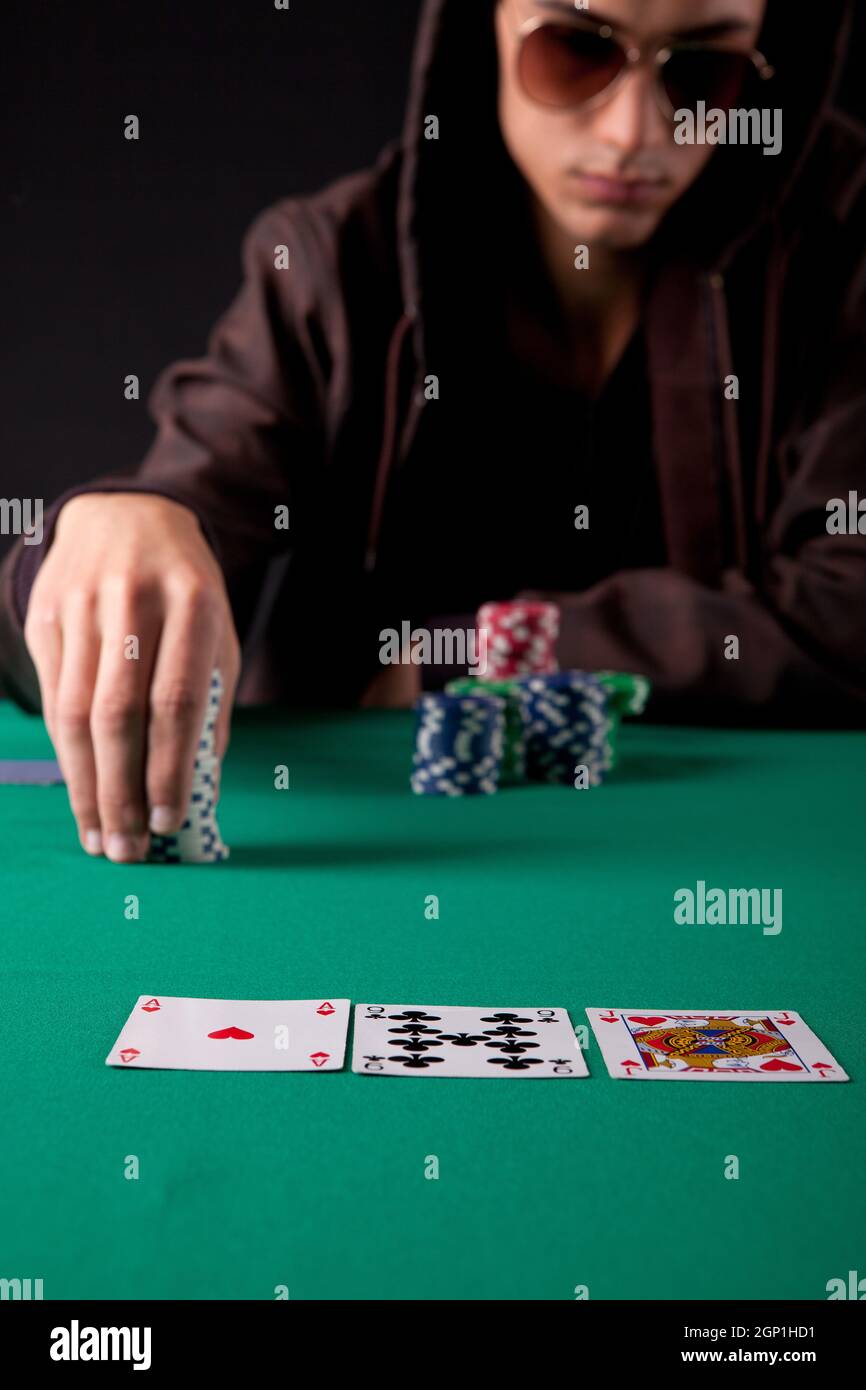 Young handsome man playing texas hold'em poker Stock Photo - Alamy