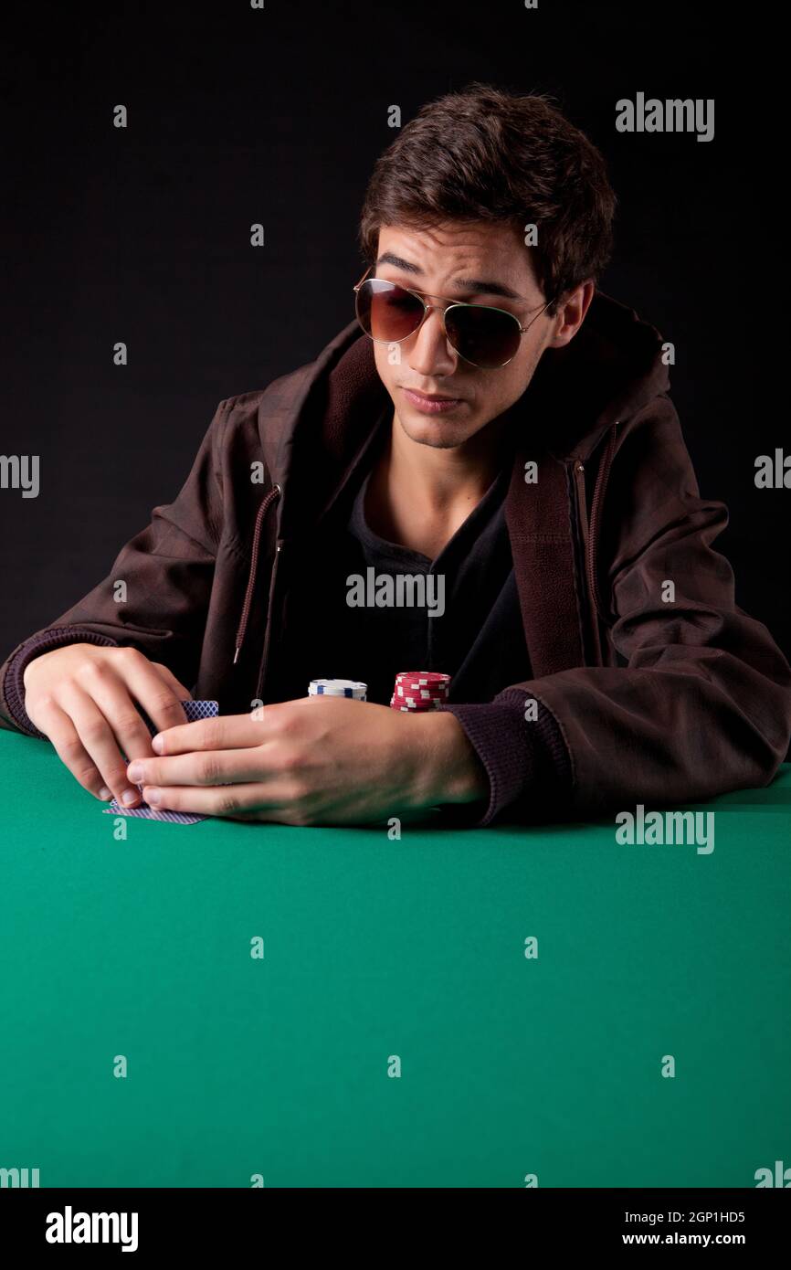 Young handsome man playing texas hold'em poker Stock Photo - Alamy