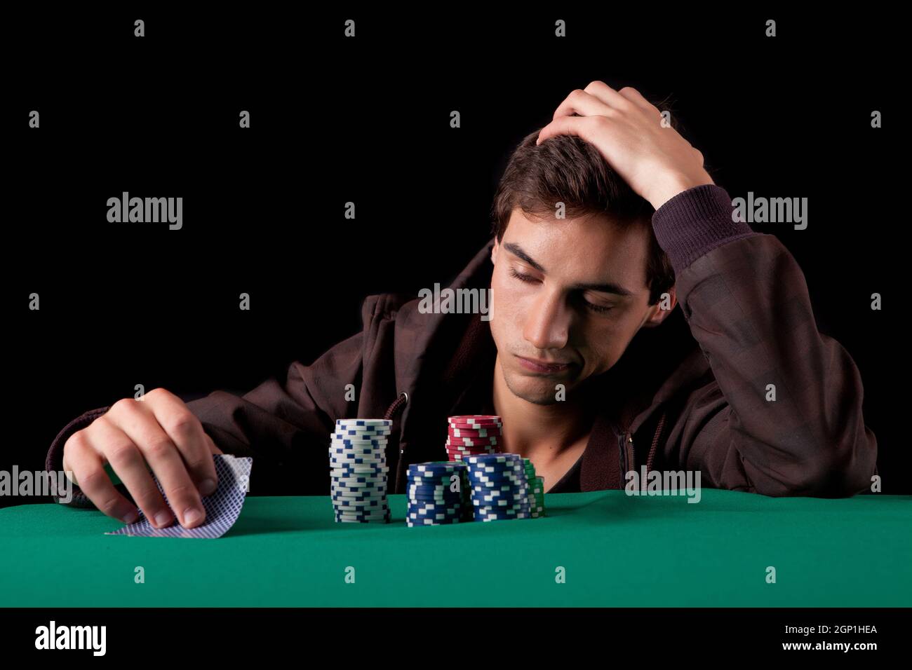 Young handsome man playing texas hold'em poker Stock Photo - Alamy