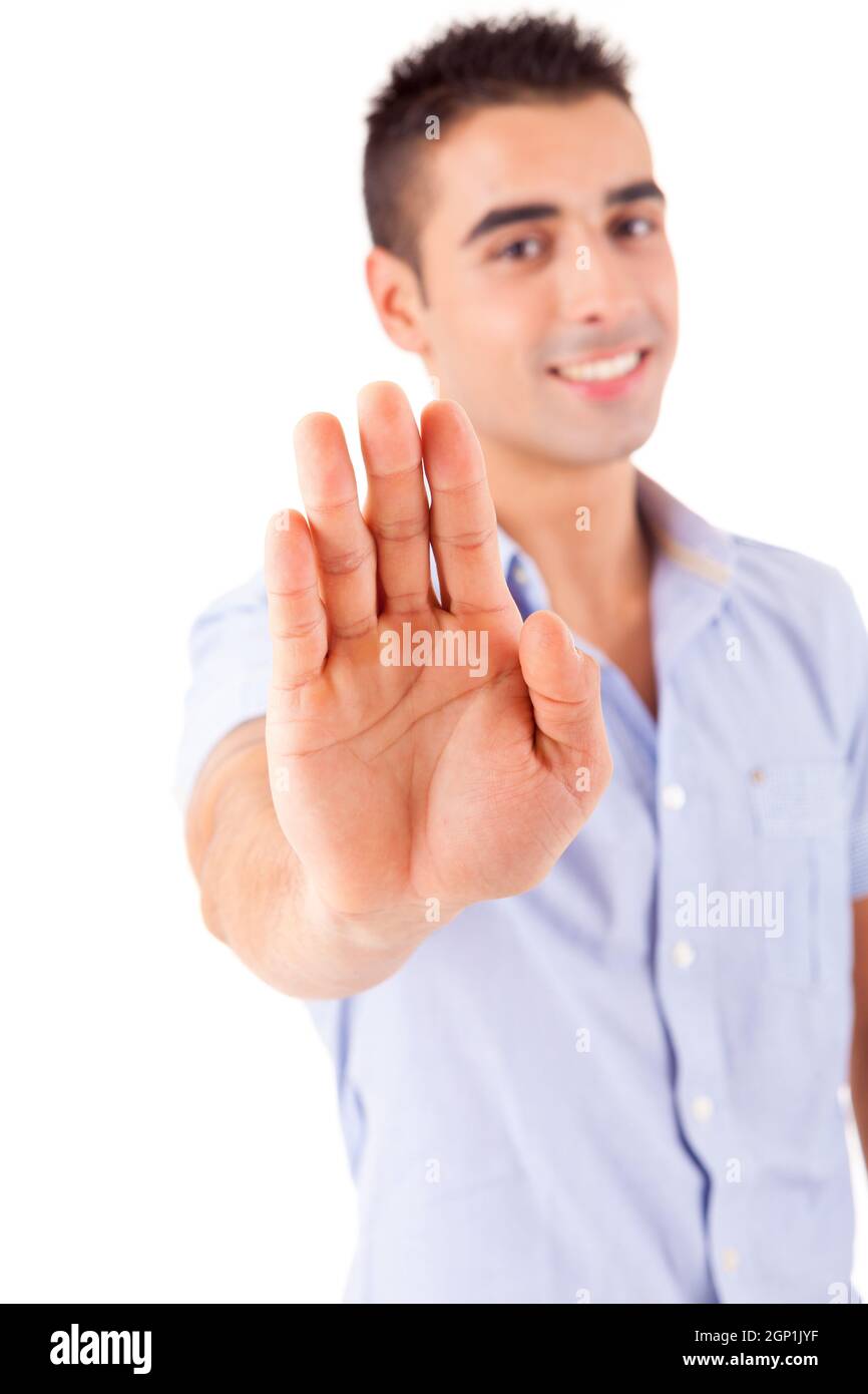 Studio shot of a young man signaling stop - isolated Stock Photo - Alamy