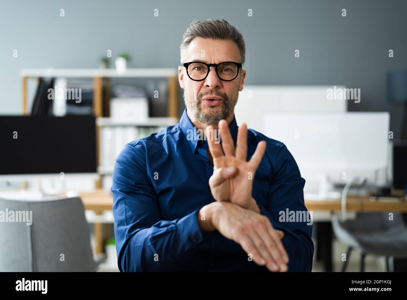 Adult Learning Sign Language For Deaf Disabled Stock Photo - Alamy