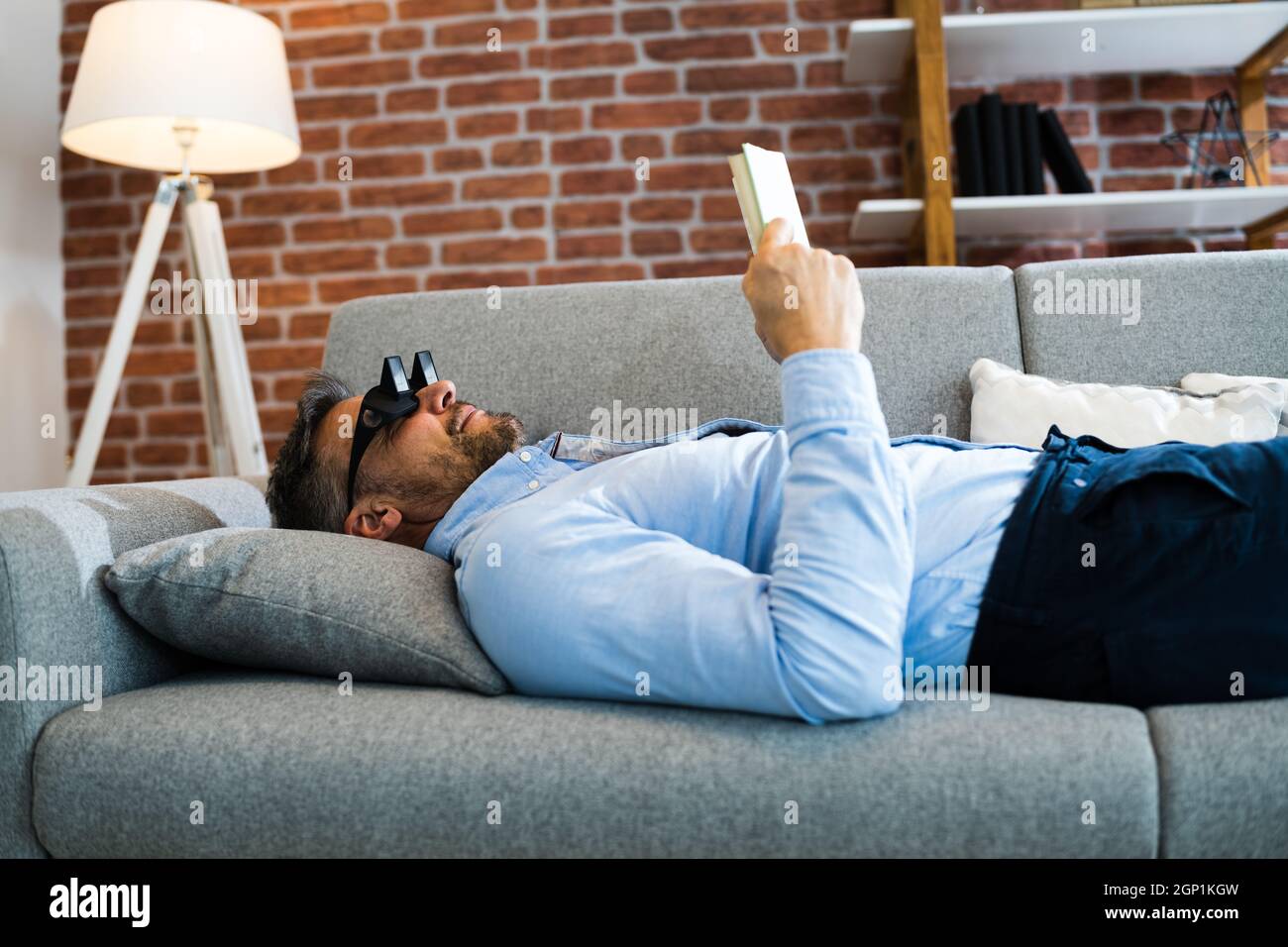 Man Using Lazy Reading Prism Glasses To Read Book Stock Photo - Alamy