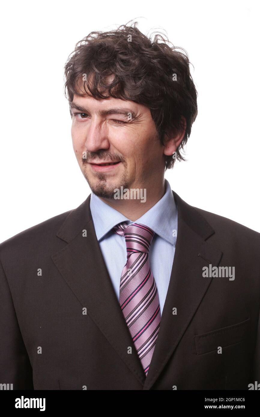 Portrait of young businessman, blinking an eye and isolated on white ...