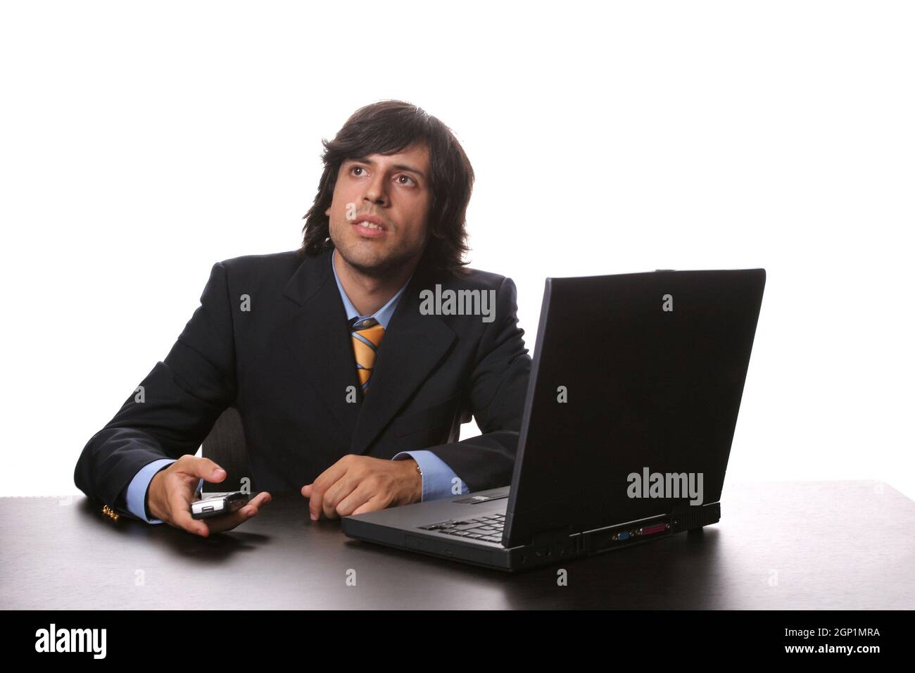 young business man working with his laptop and calling on cellphone ...