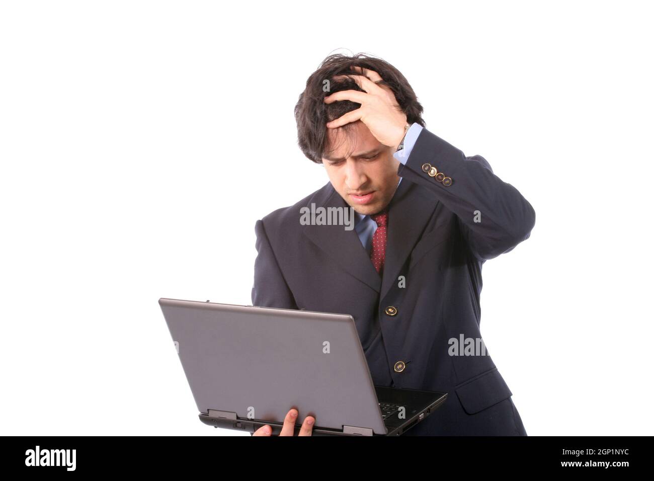 Young woried business man working with laptop, isolated on white ...