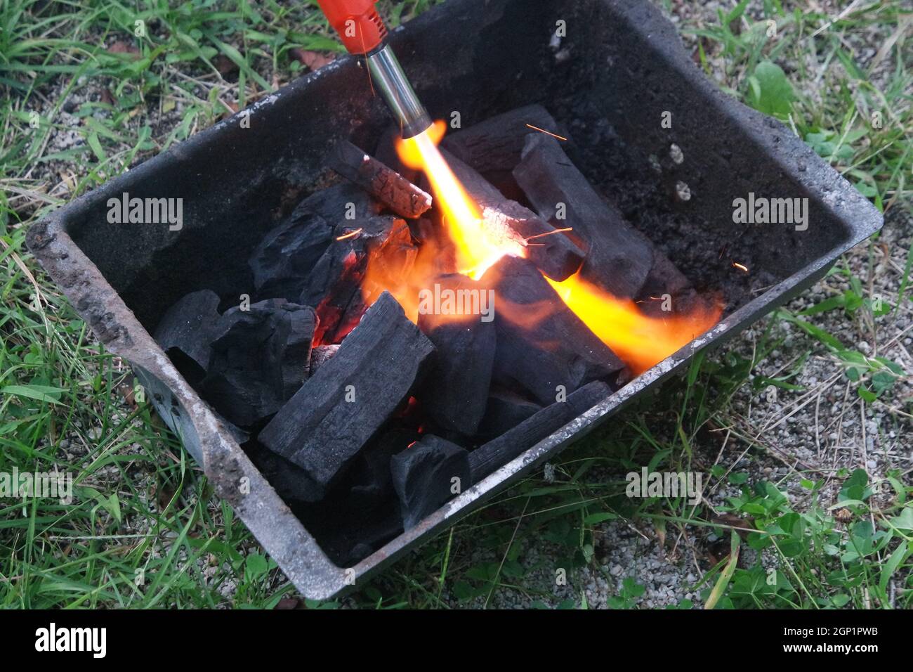 Fire on logs in fire pot with embers and burning coal. Bonfire with ...