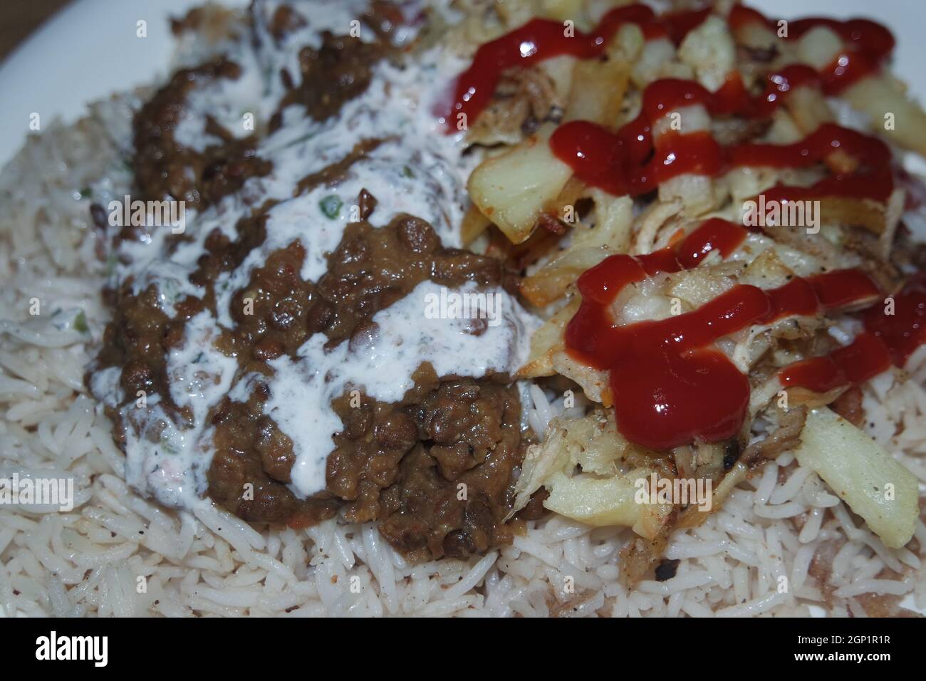 Delicious traditional dish of rice with potato fries and cereals with ...