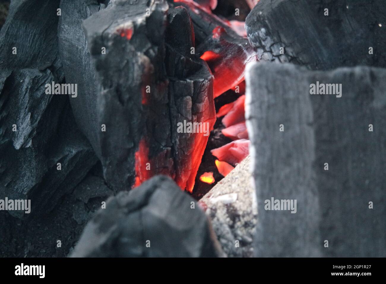 Fire on logs in fire pot with embers and burning coal. Bonfire with ...