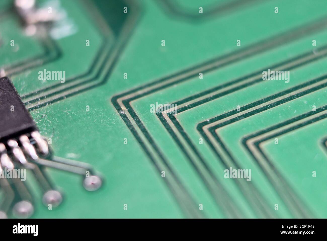 Electronic board with circuit lines and chip. Macro view of green board ...