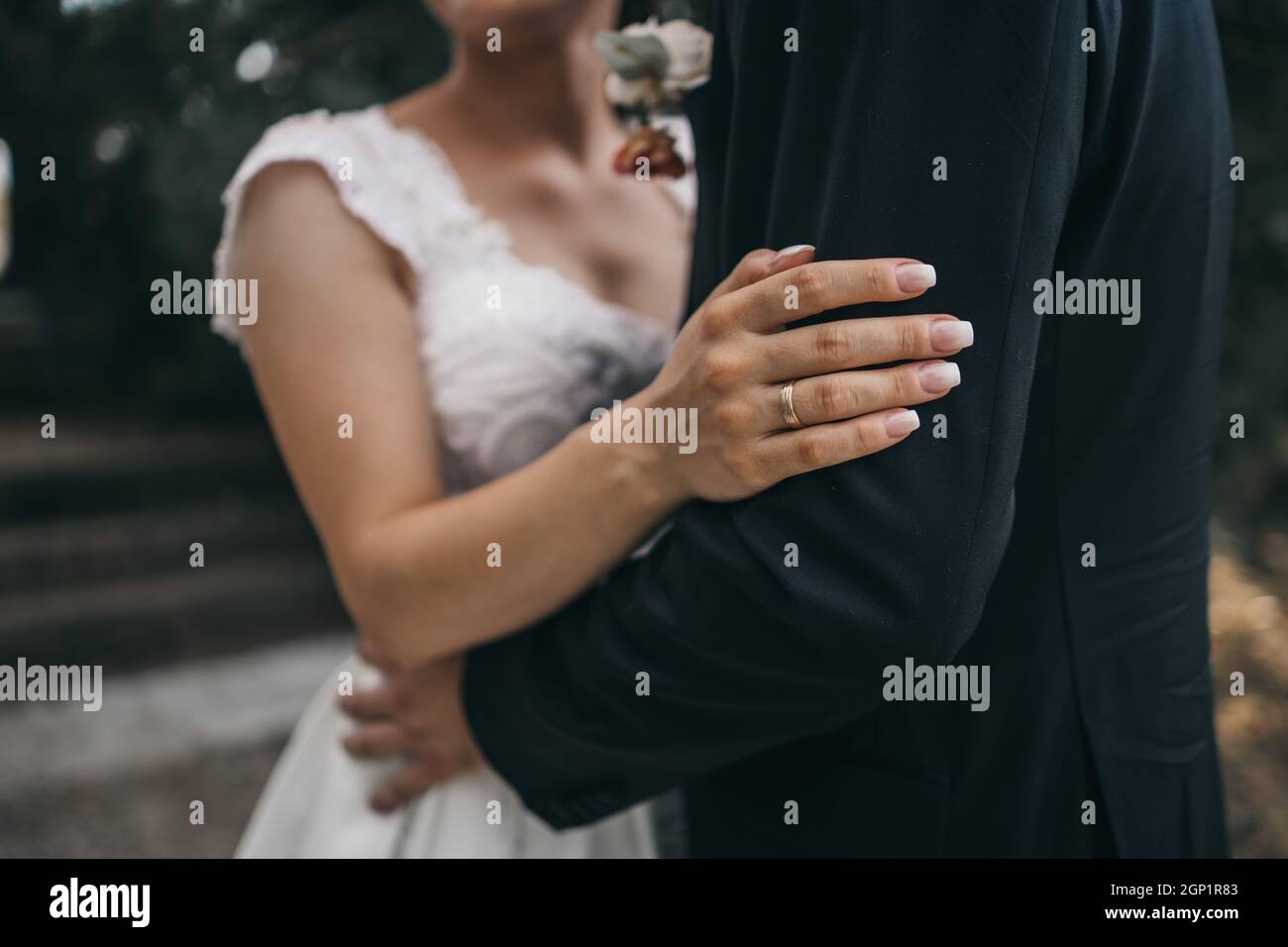 Selective focus shot of the bride and the groom during their wedding ...