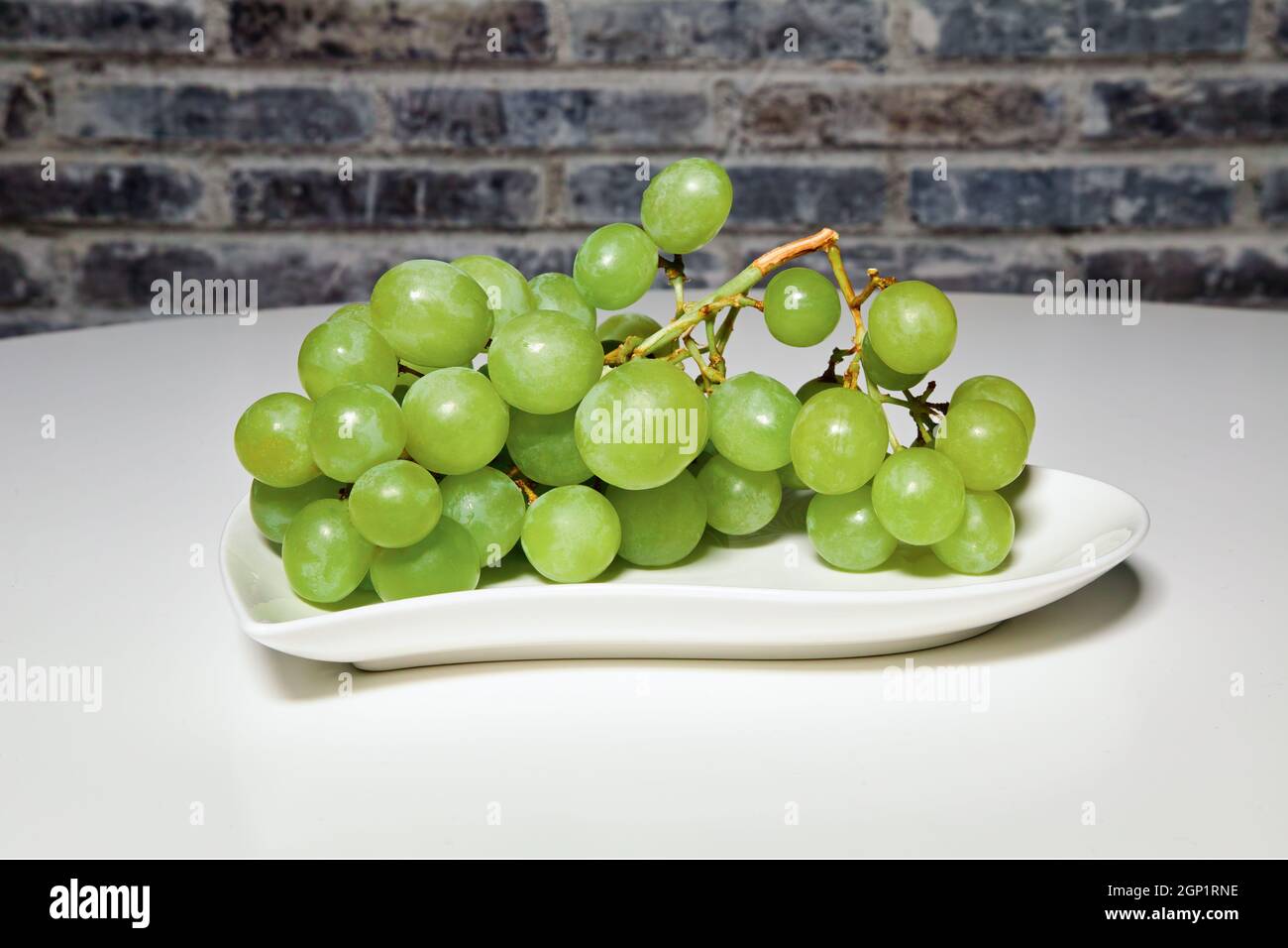 Grapes on a heart shaped plate, studio shot Stock Photo - Alamy