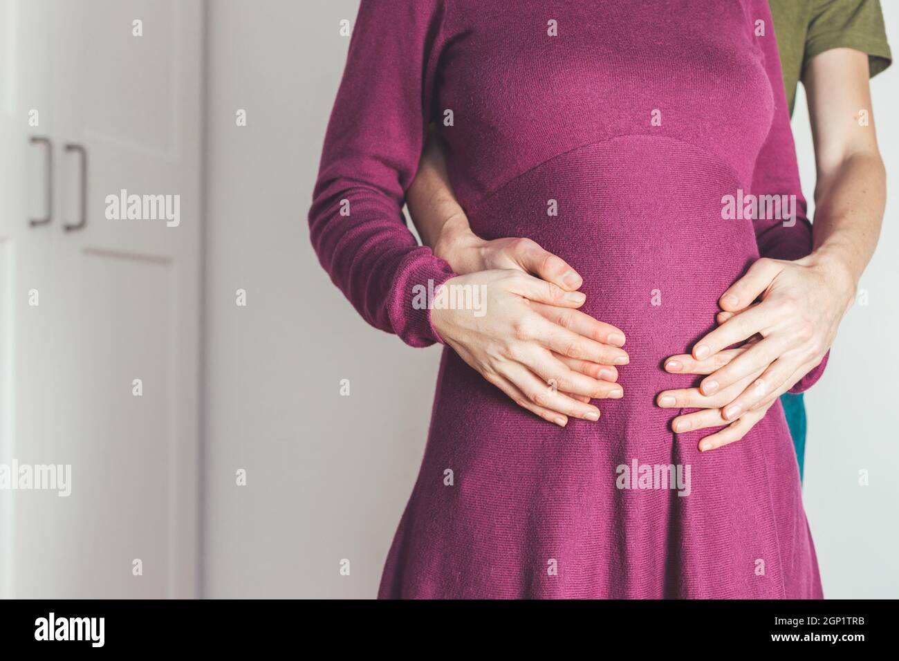 Close up of pregnant mother and father, hugging the tummy, Caucasian ...