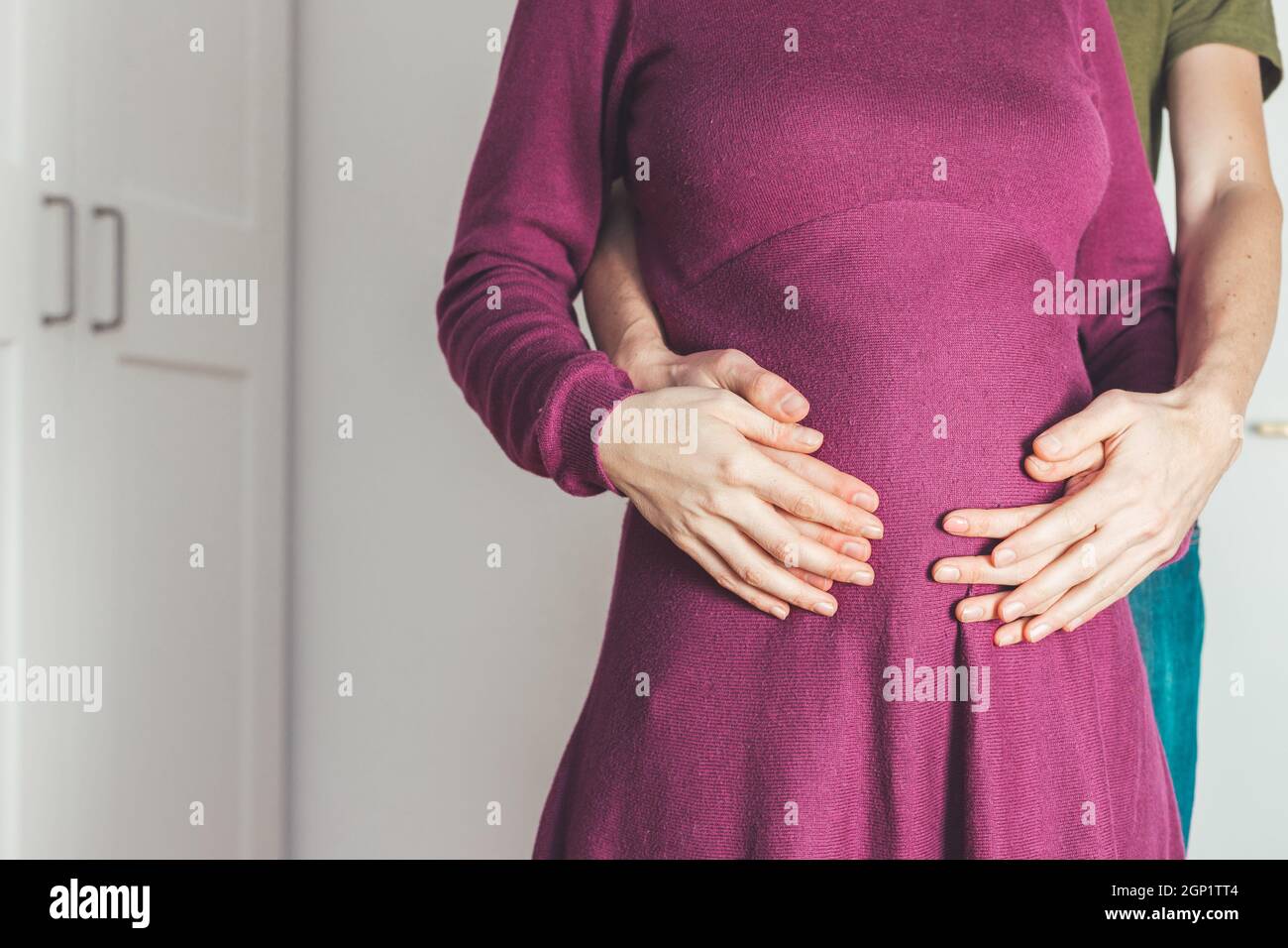Pregnant mother hugging child hi-res stock photography and images - Alamy