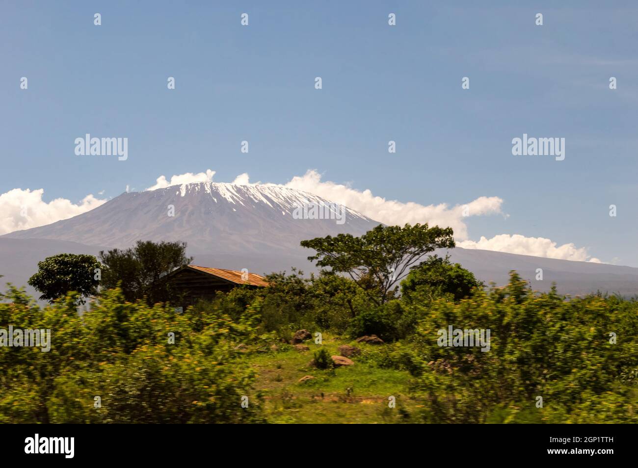 Snow capped Kenya's Kilimanjaro mountain under cloudy blue sky captured ...