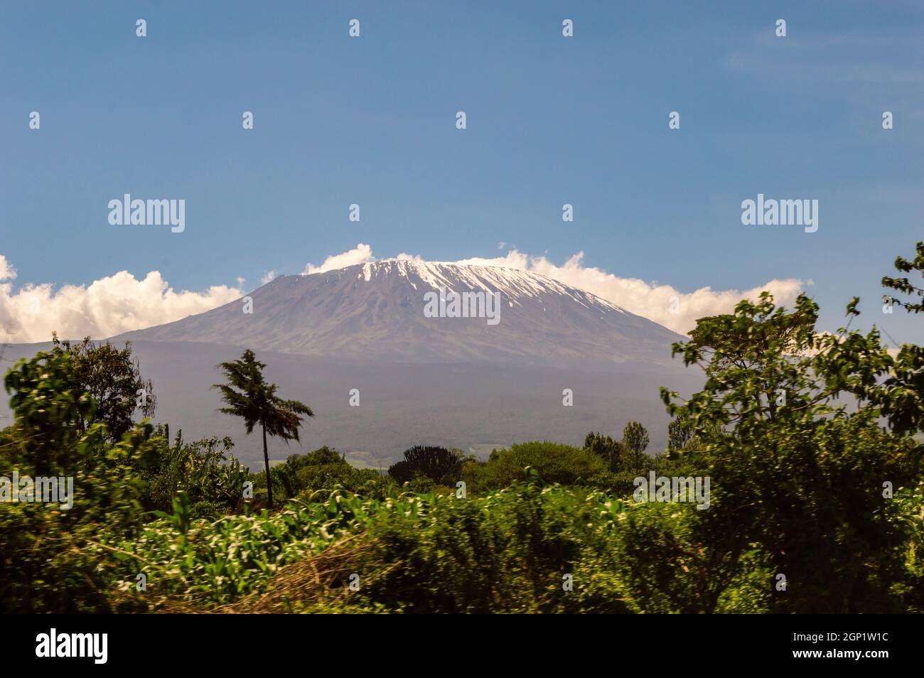 Snow capped Kenya's Kilimanjaro mountain under cloudy blue sky captured ...