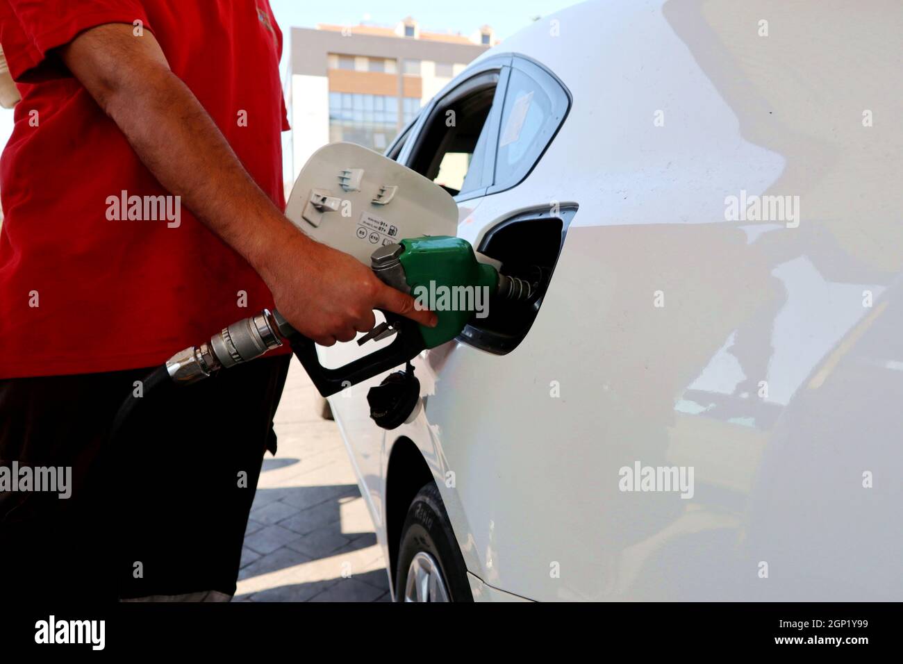 A worker at a petrol station refills a car in Beirut, Lebanon on ...