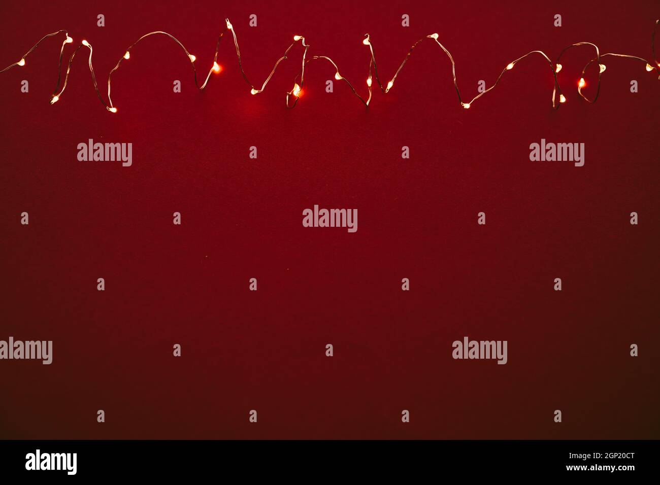 Red background with illuminated lights of garland Stock Photo - Alamy