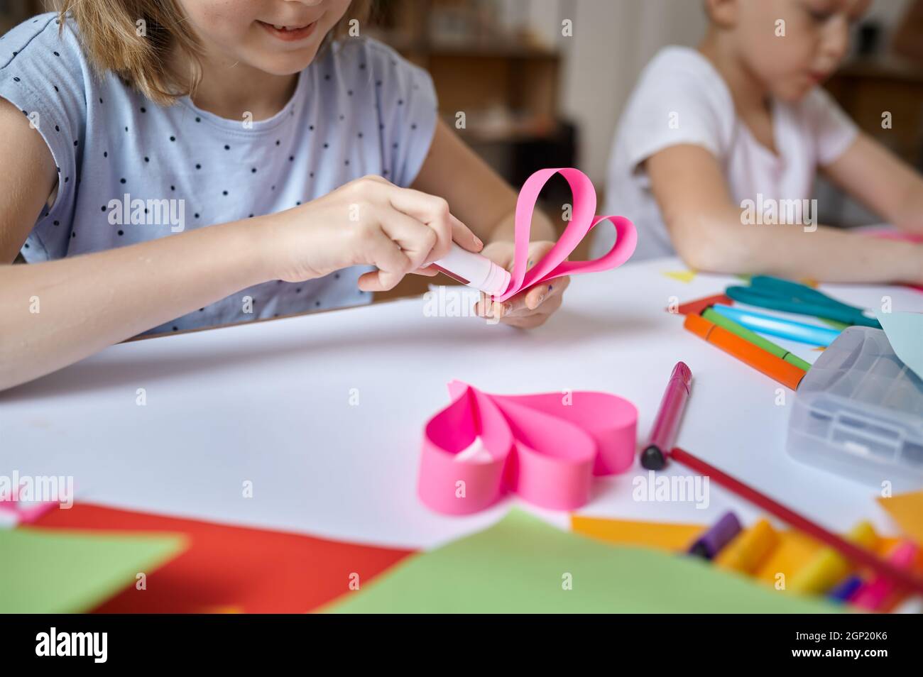 Two children glue colored paper, art school Stock Photo - Alamy