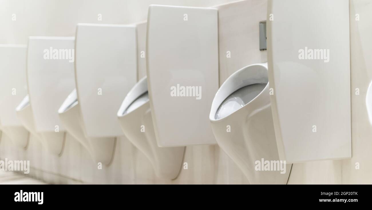 Sensor-operated urinals with privacy walls in a public men's toilet ...