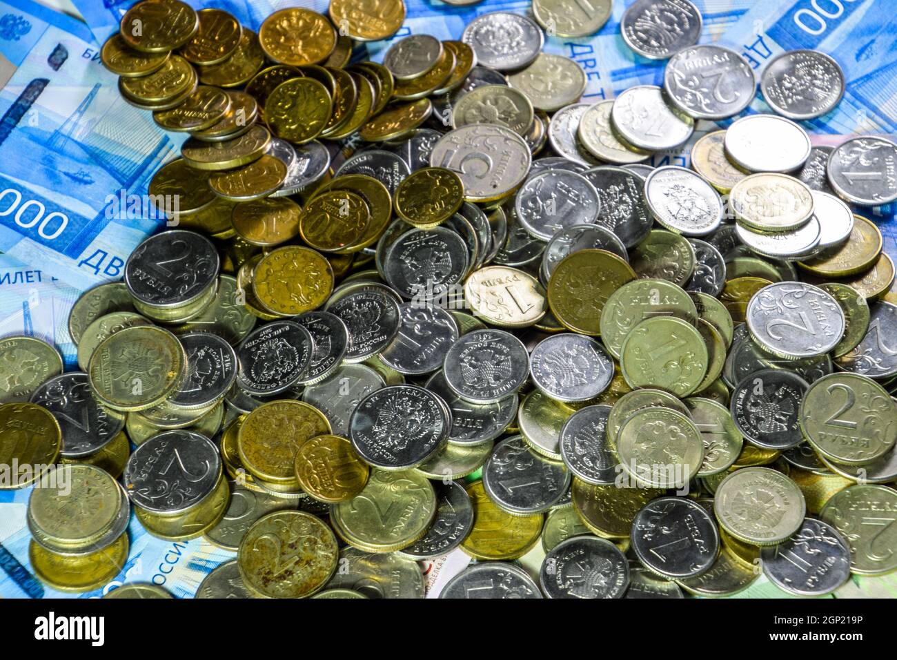 Russian banknotes and coins. A handful of coins on new Russian ...