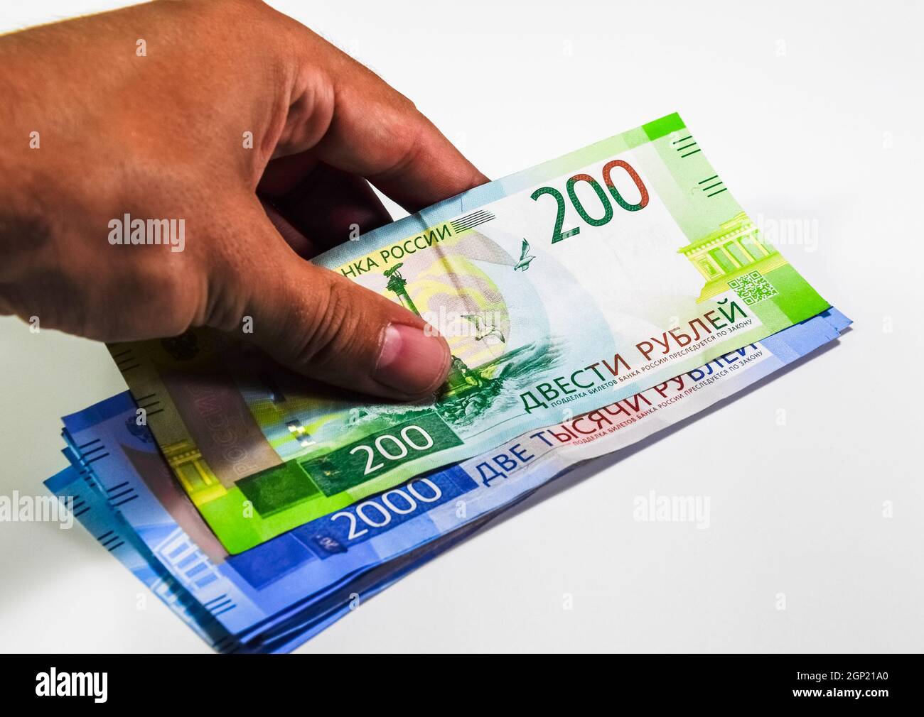 A Bundle Of Money In His Hand Russian Rubles Banknotes Of 200 And A Bundle Of Money In His Hand Russian Rubles Banknotes Of 200 And