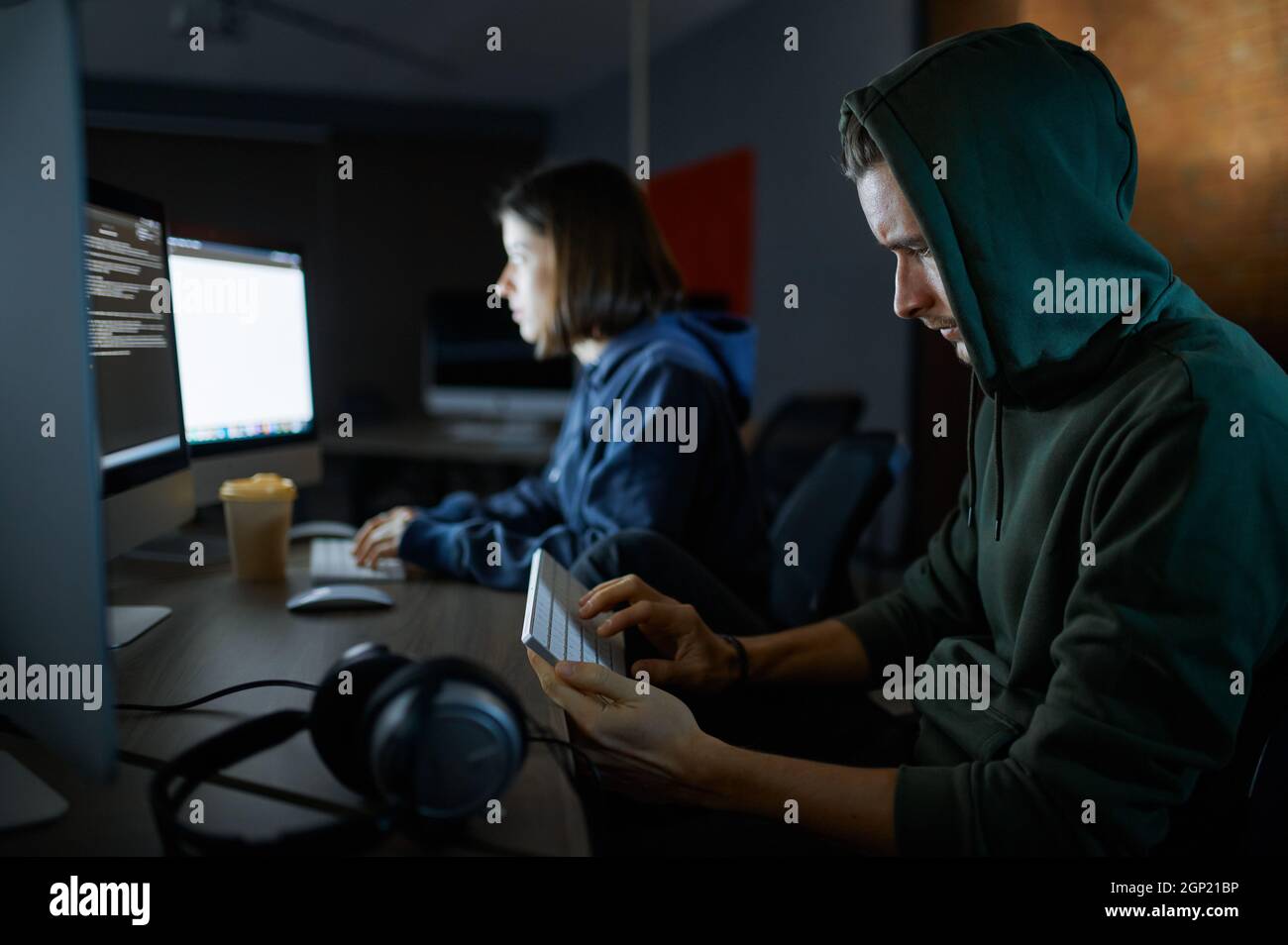 Hacker works computers in dark hi-res stock photography and images - Alamy